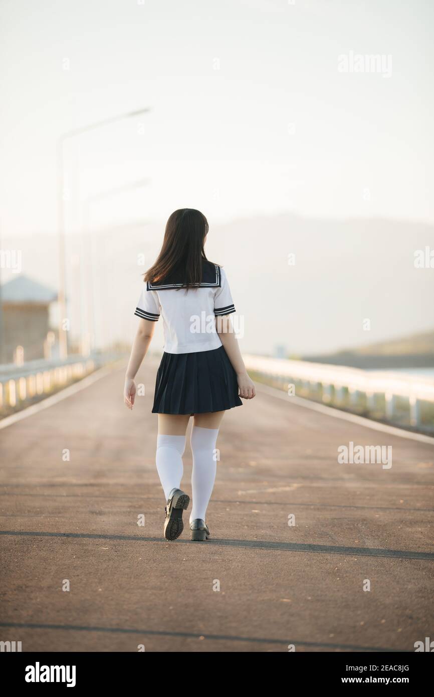 Portrait of Japanese school girl uniform smile with walkway and river ...