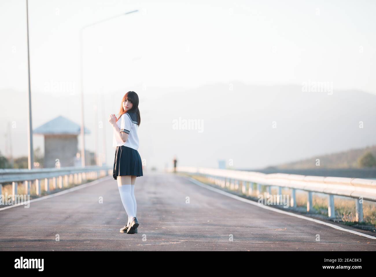 Portrait of Japanese school girl uniform smile with walkway and river ...