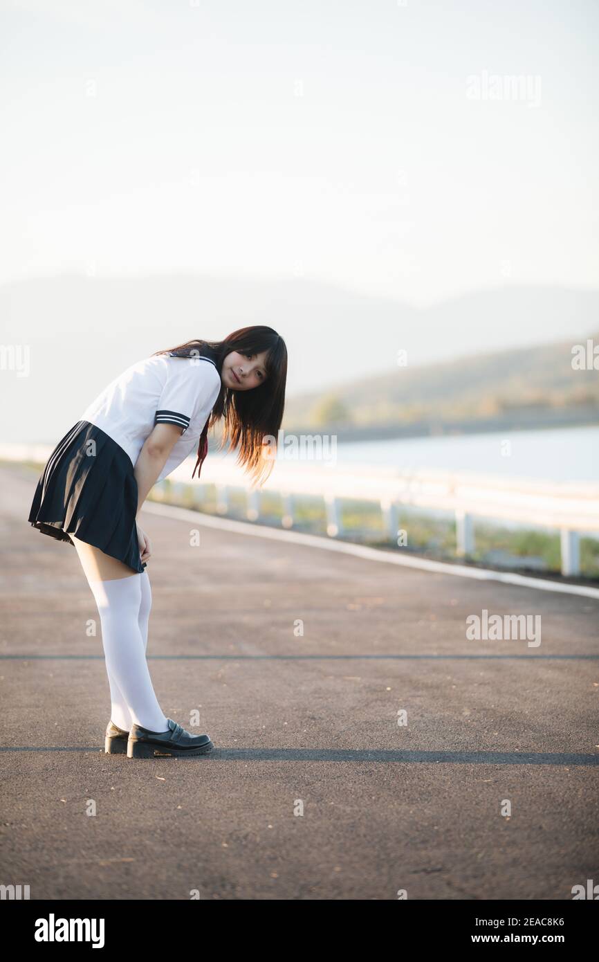 Portrait of Japanese school girl uniform smile with walkway and river ...
