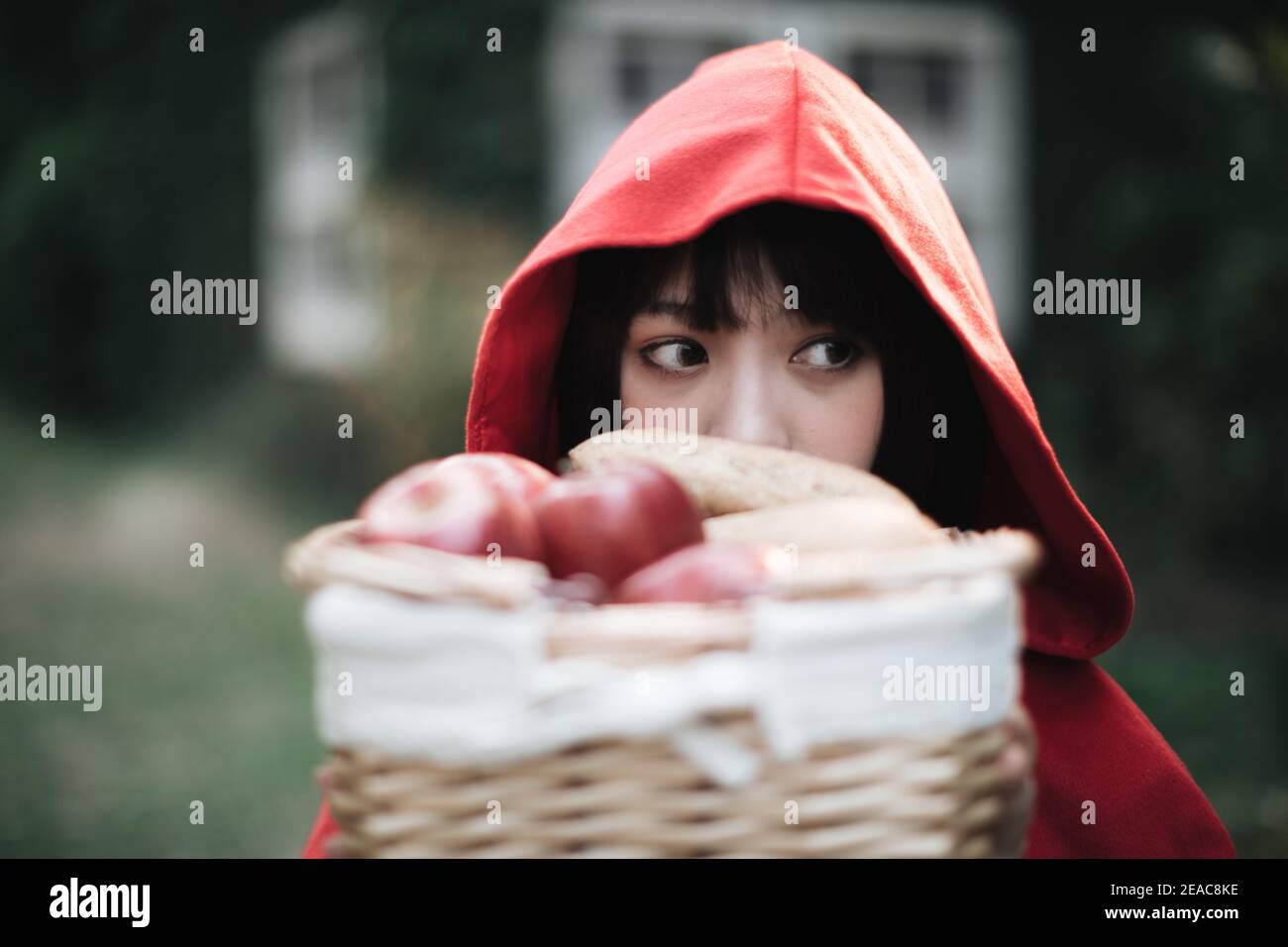 Portrait young woman with Little Red Riding Hood costume in green tree ...