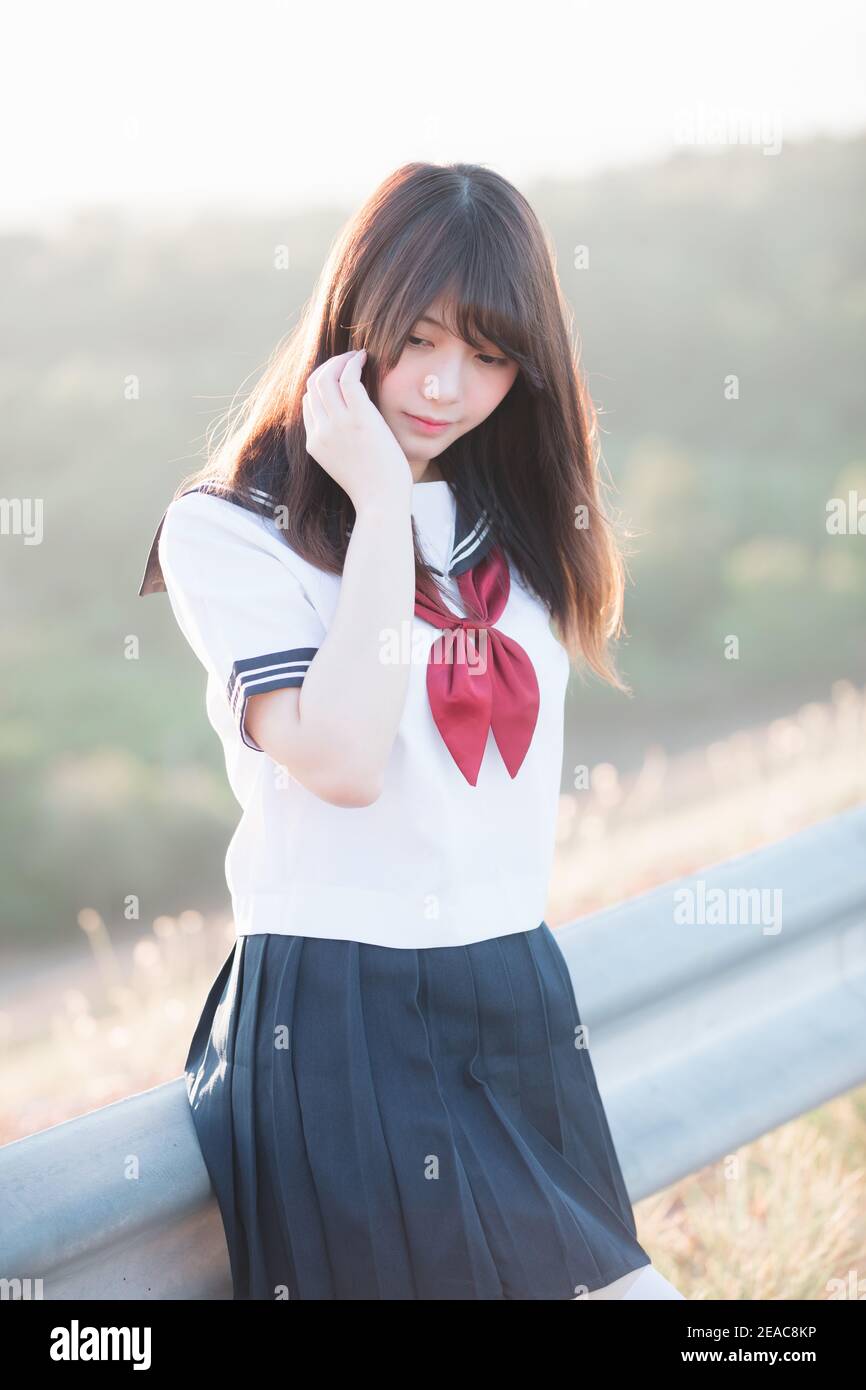 Portrait of Japanese school girl uniform smile with walkway and river ...