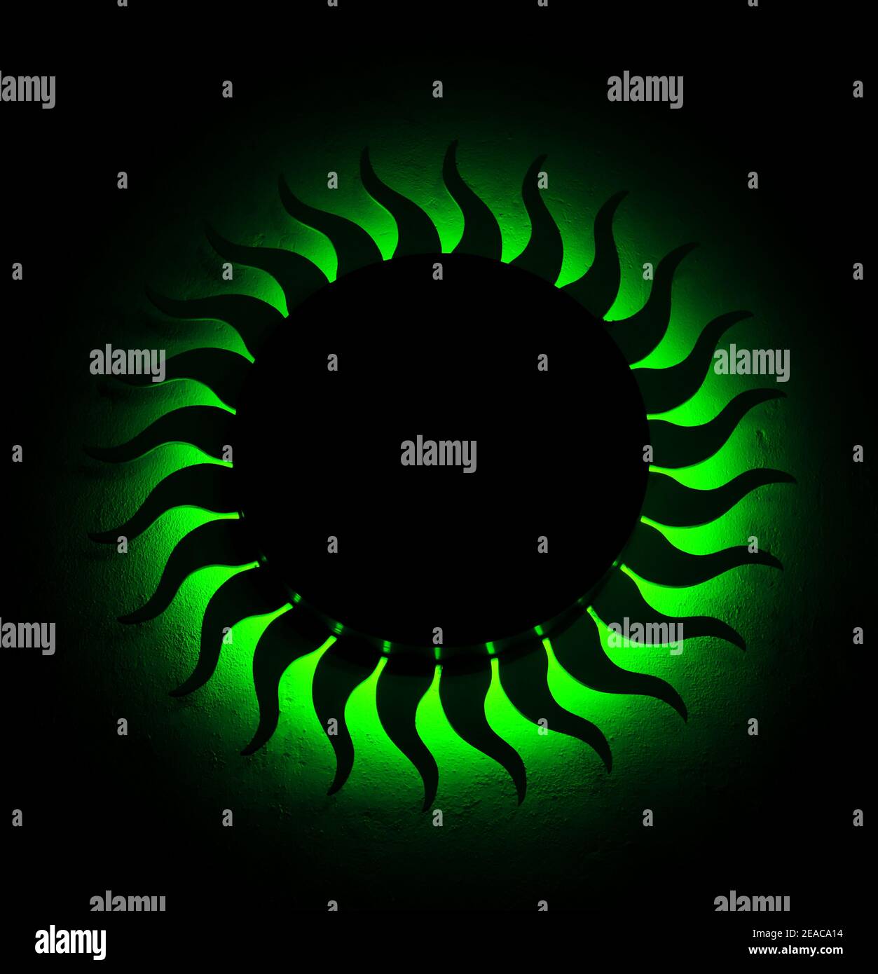 green sun with led on the wall Stock Photo - Alamy