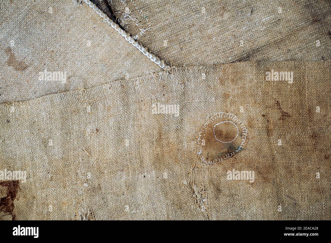 old jute sack with patched hole Stock Photo - Alamy