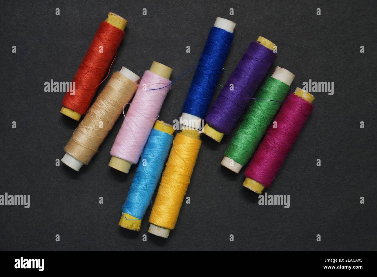 Group of threads in a dark background Stock Photo - Alamy