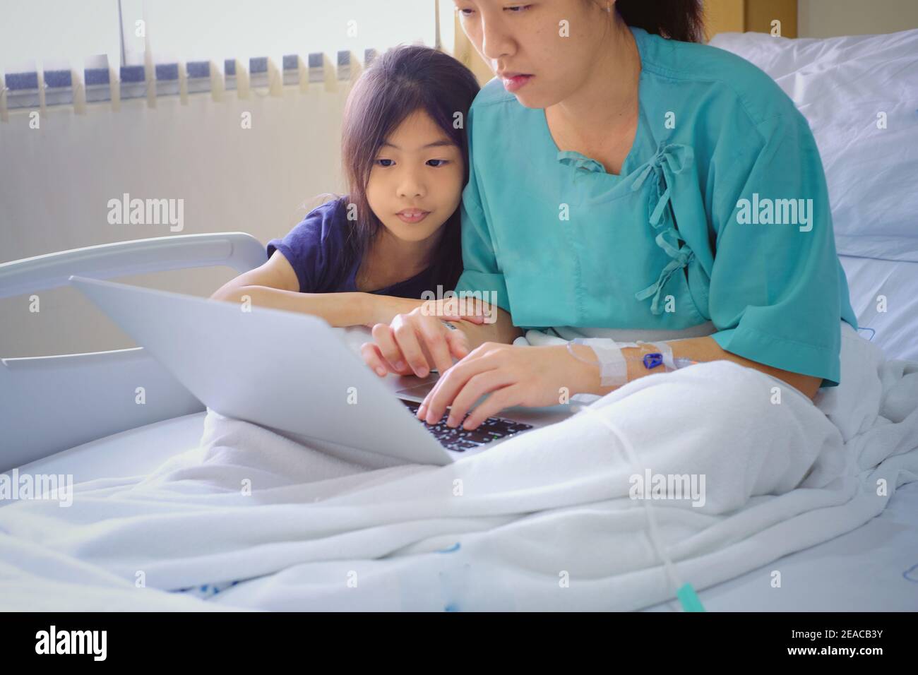 A half body shot of a workaholic business woman sitting in a hospital ...