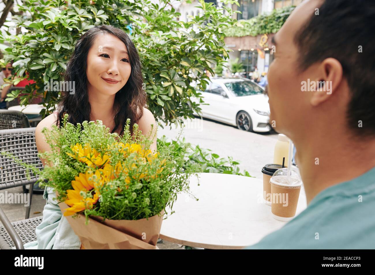 Accepting flowers from boyfriend Stock Photo - Alamy