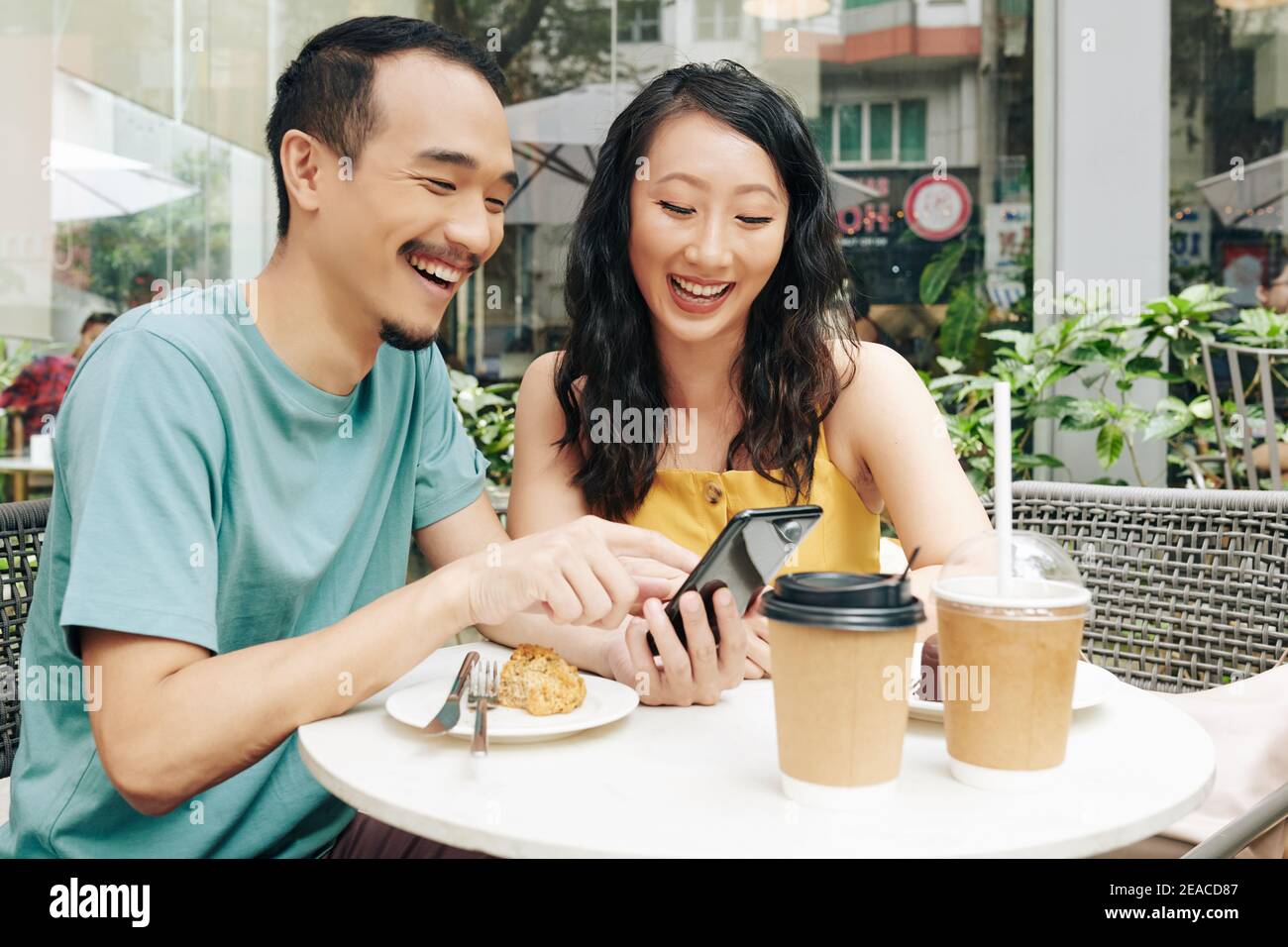 Couple discusing funny memes Stock Photo - Alamy