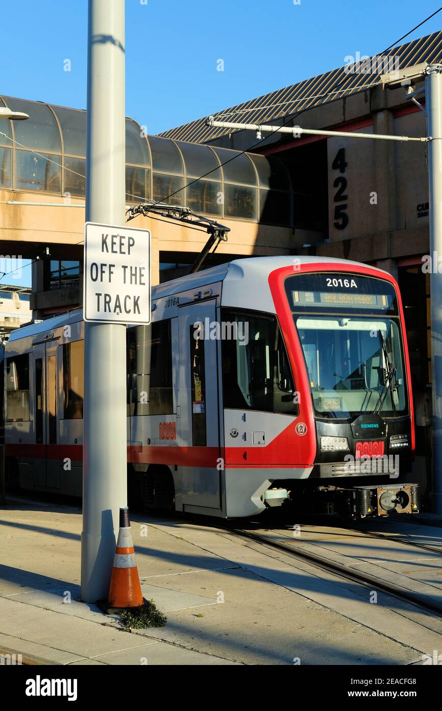 Keep off the track sign in front of a BART metro train car in San ...