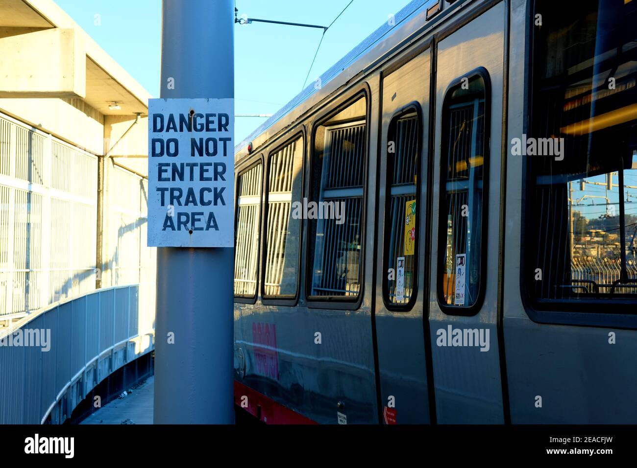 Danger do not enter track area sign in front of a BART metro train car ...