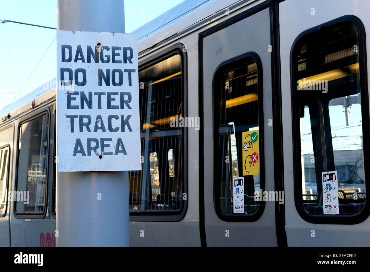 Danger do not enter track area sign in front of a BART metro train car ...