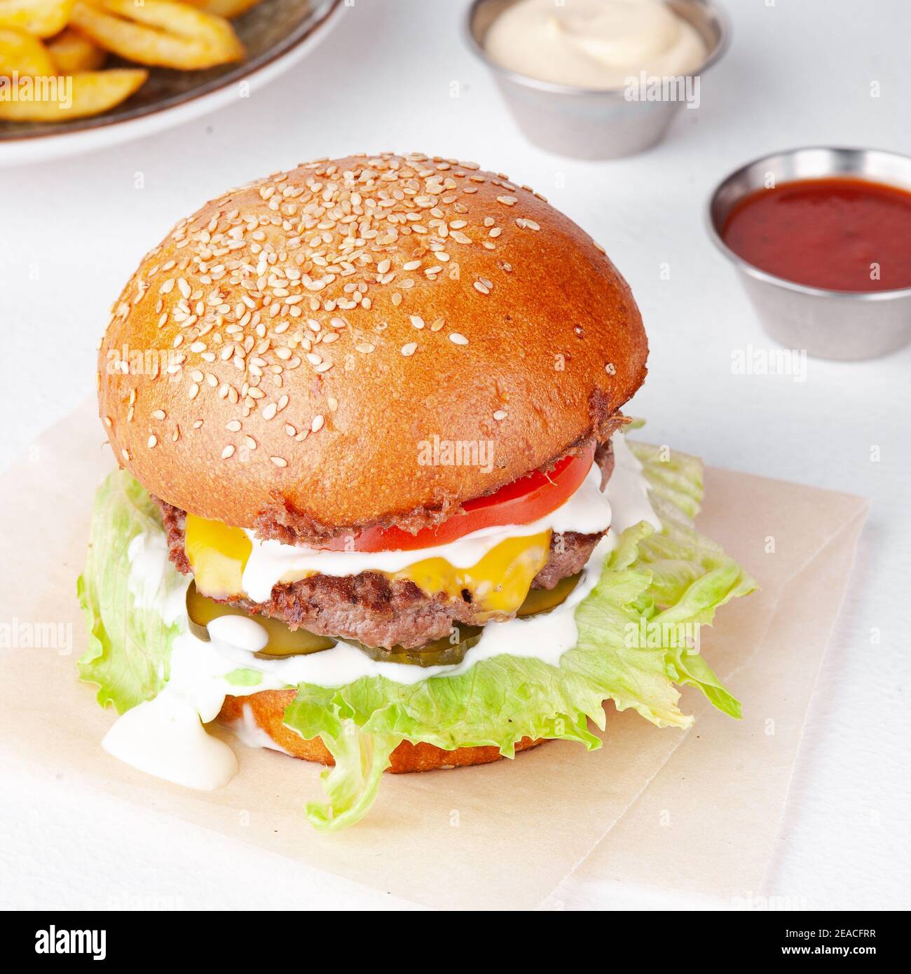 Sesame burger and french fries in restaurant Stock Photo - Alamy