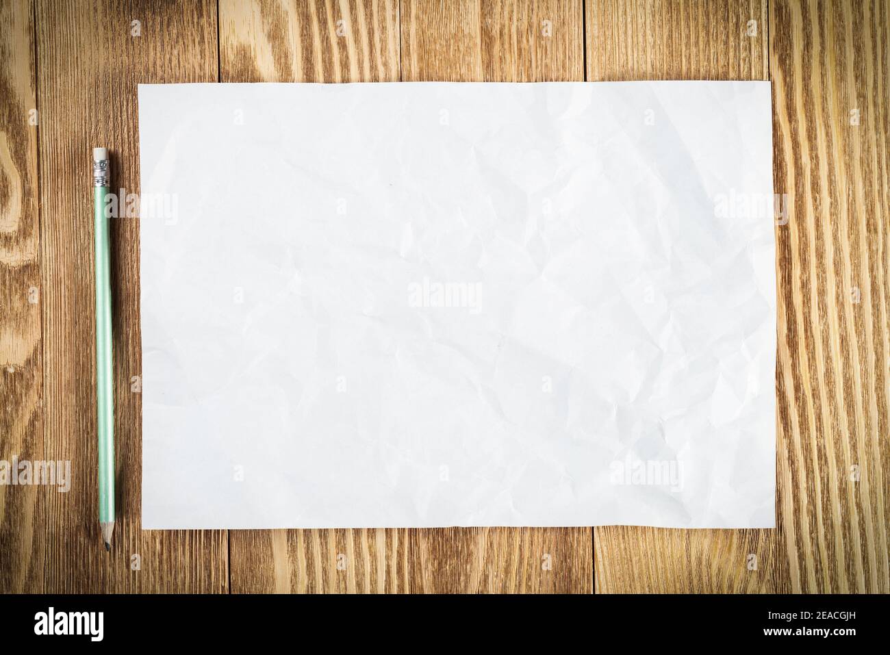 Sheet of paper lying on wooden table Stock Photo - Alamy
