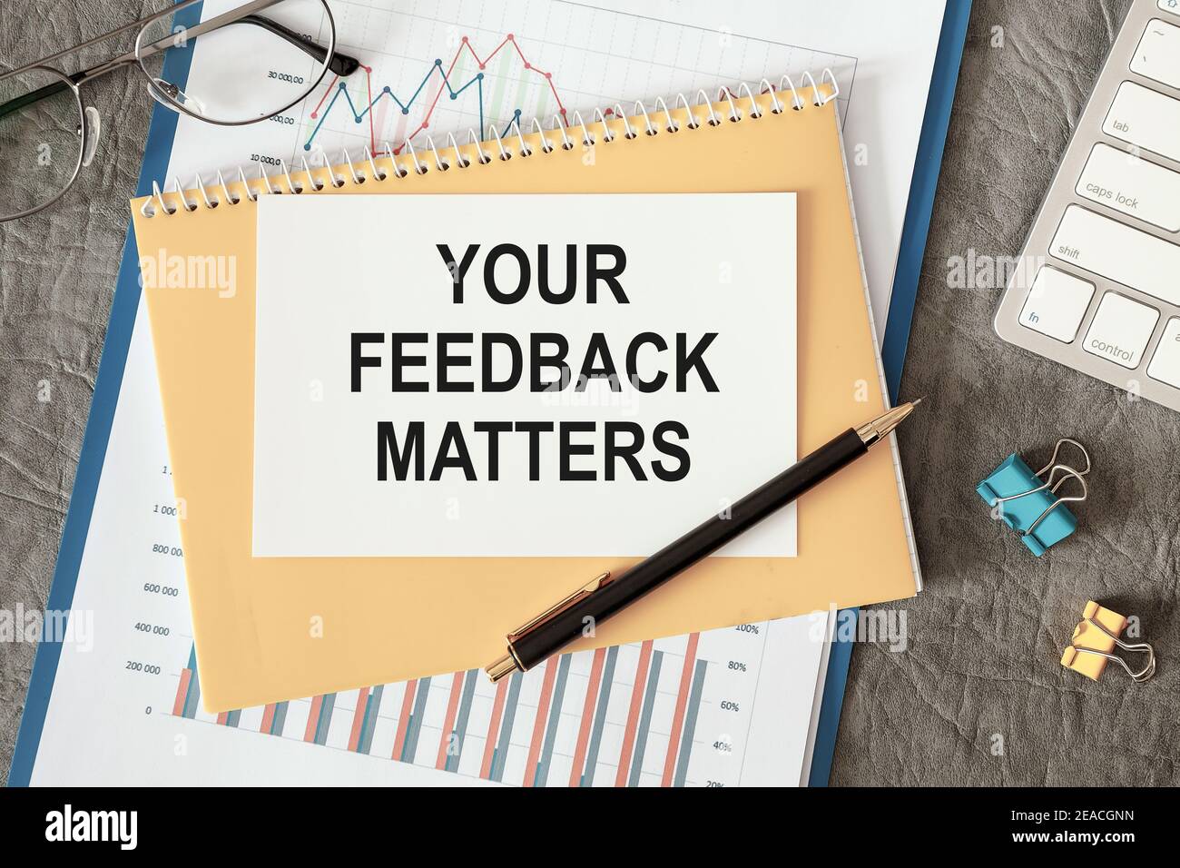 YOUR FEEDBACK MATTERS is written in a document on the office desk with ...