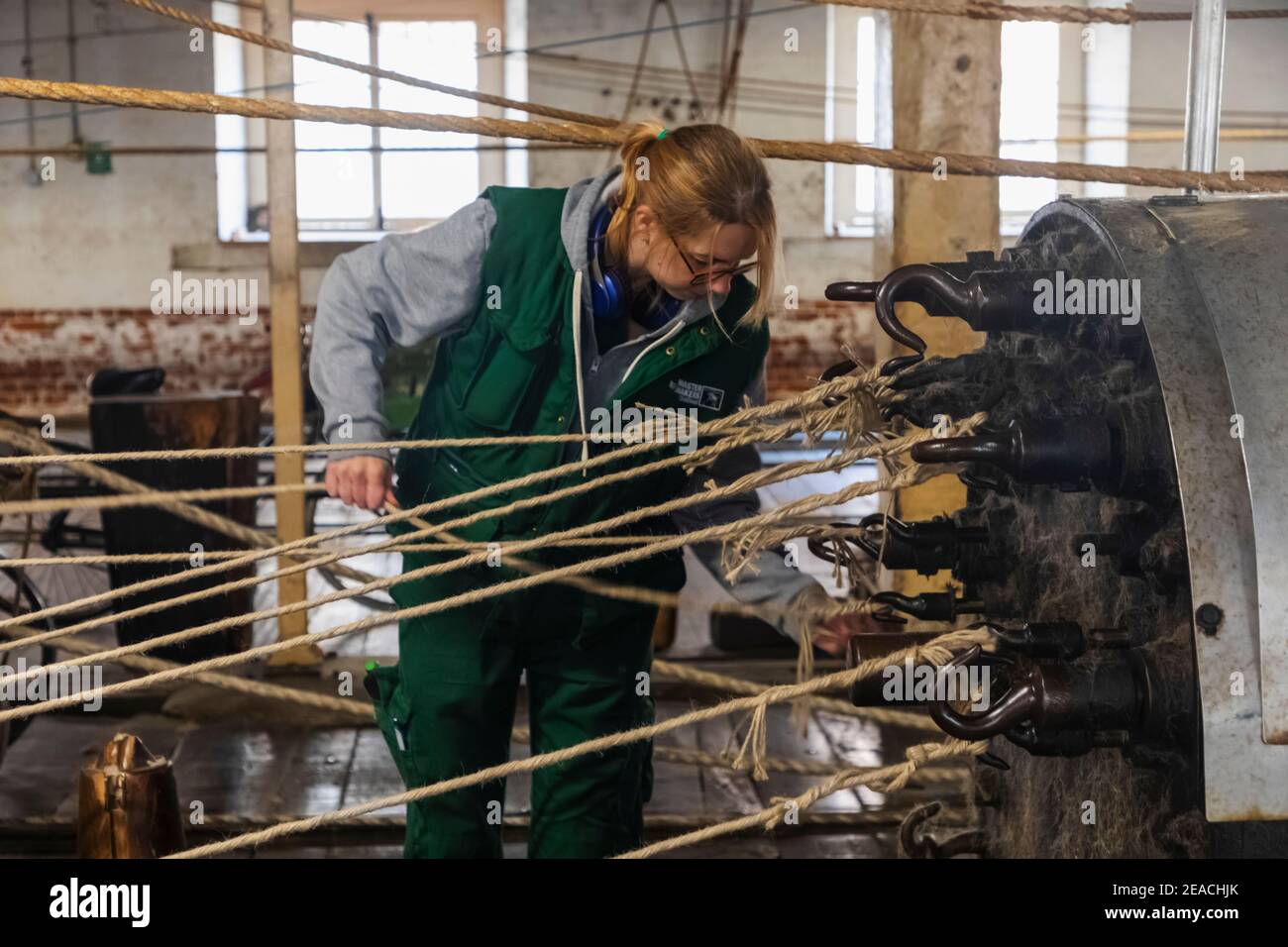 Female worker attaching rope to spinning machine hi-res stock ...