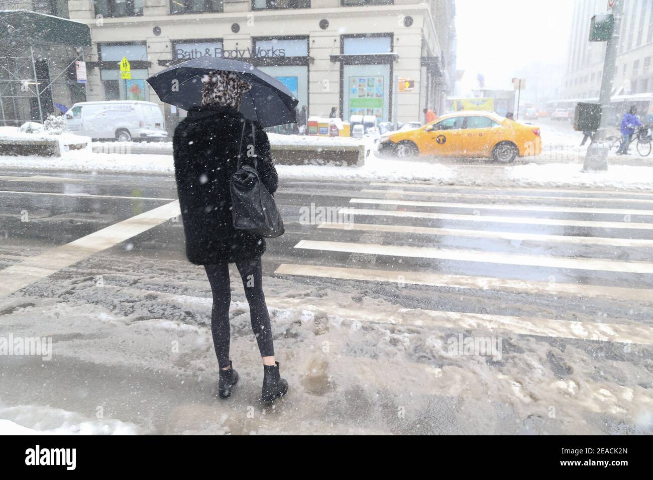 New York City, NY USA Woman walking through slush and snow on 23rd ...
