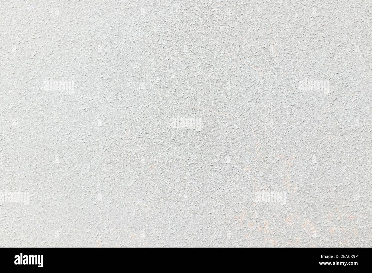 White plaster on a wall conceals the rough surface of it, but still is ...