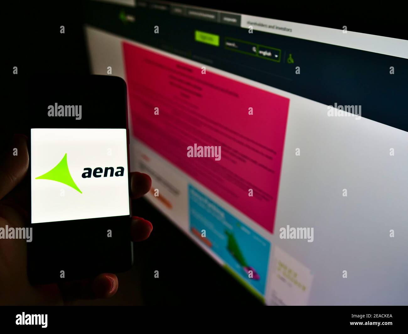 Person holding mobile phone with logo of Spanish airport operator Aena ...
