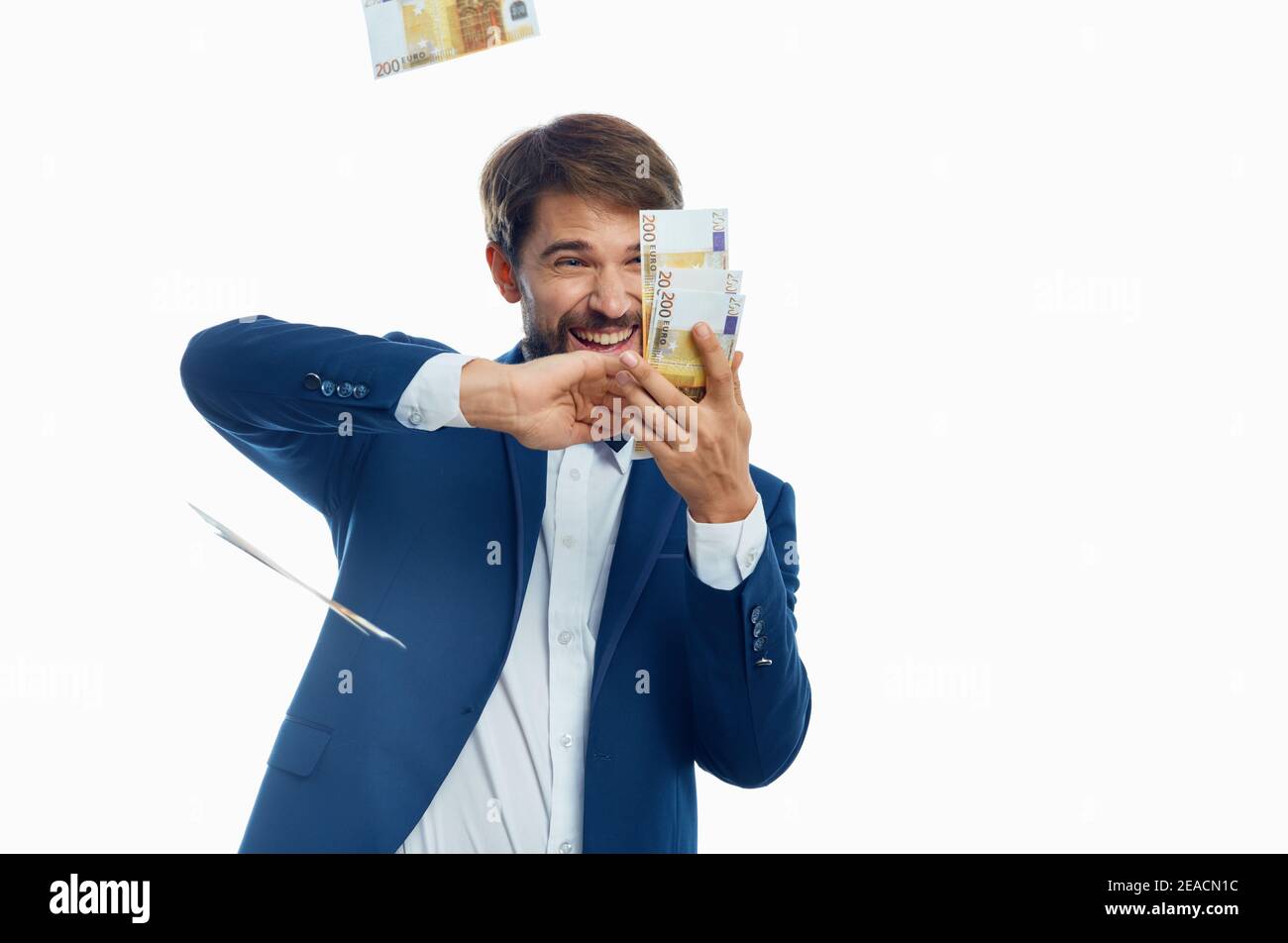 happy man scatter money on light background suit model business finance ...