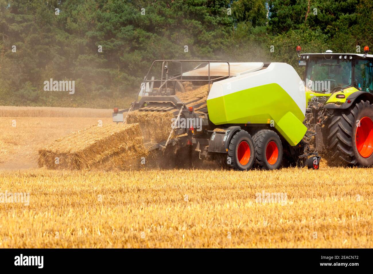 Harvesting kit with a tractor and a straw press Stock Photo - Alamy