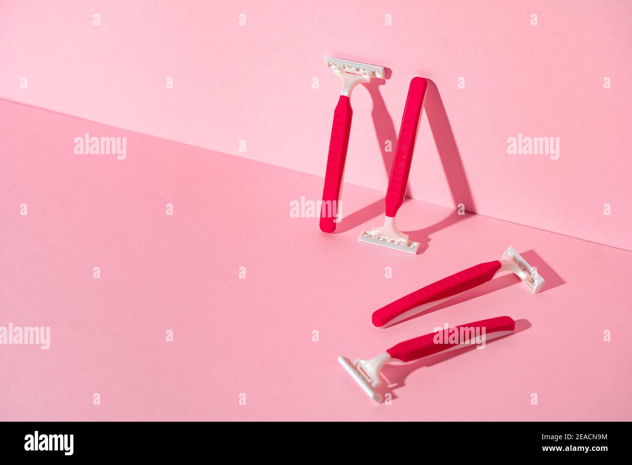 Pink disposable razors on pink background, copy space Stock Photo - Alamy
