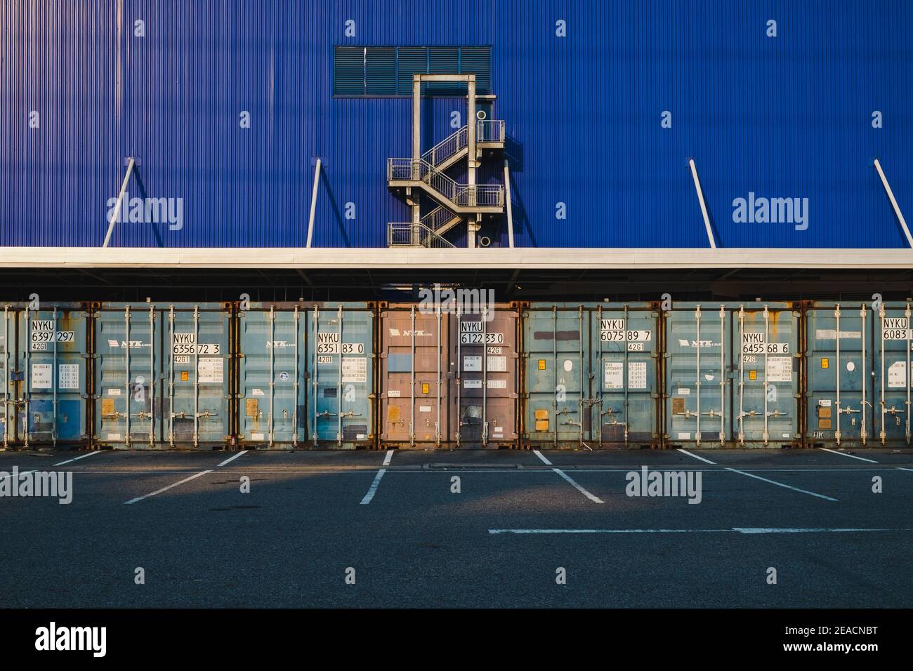 View of many shipping containers doors with fire escape background ...