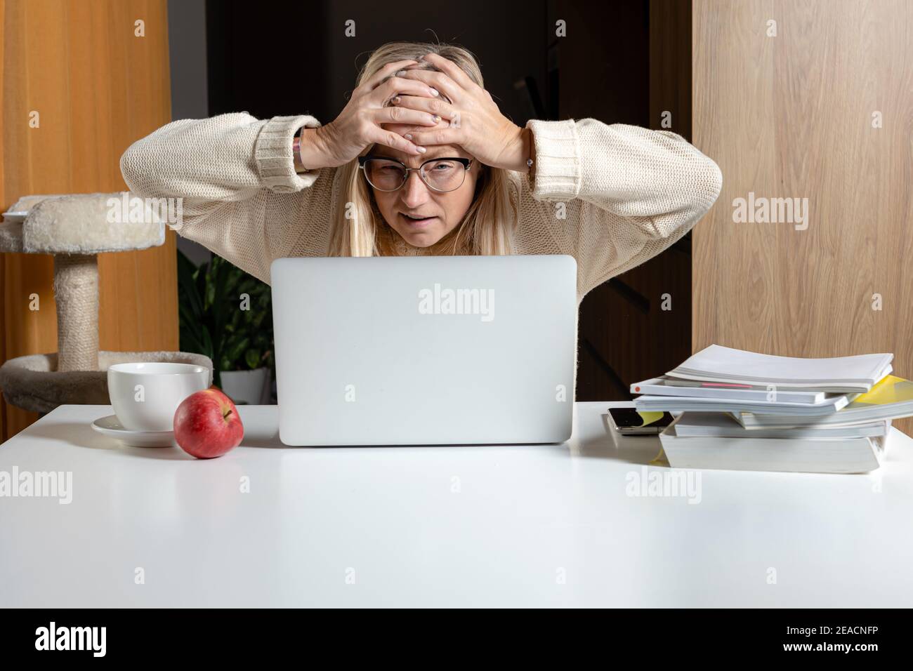 emotional freelancer woman working in home office, surprised staring at ...