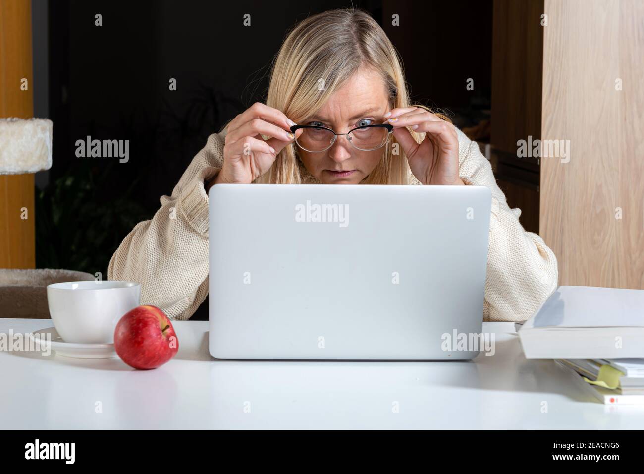 emotional freelancer woman working in home office, surprised staring at ...