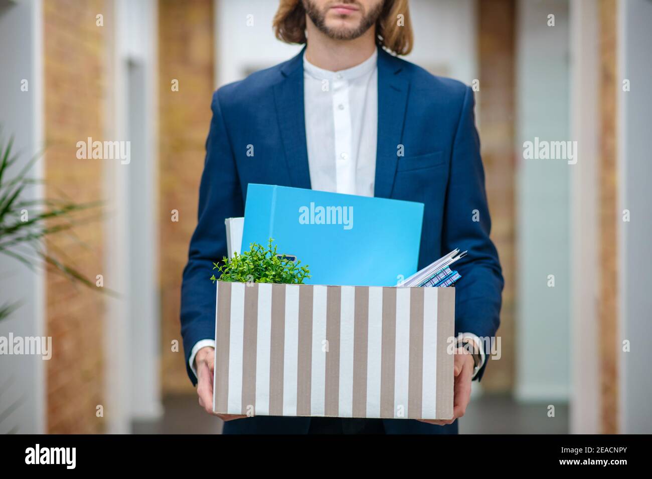 Man holding box in front of him Stock Photo - Alamy