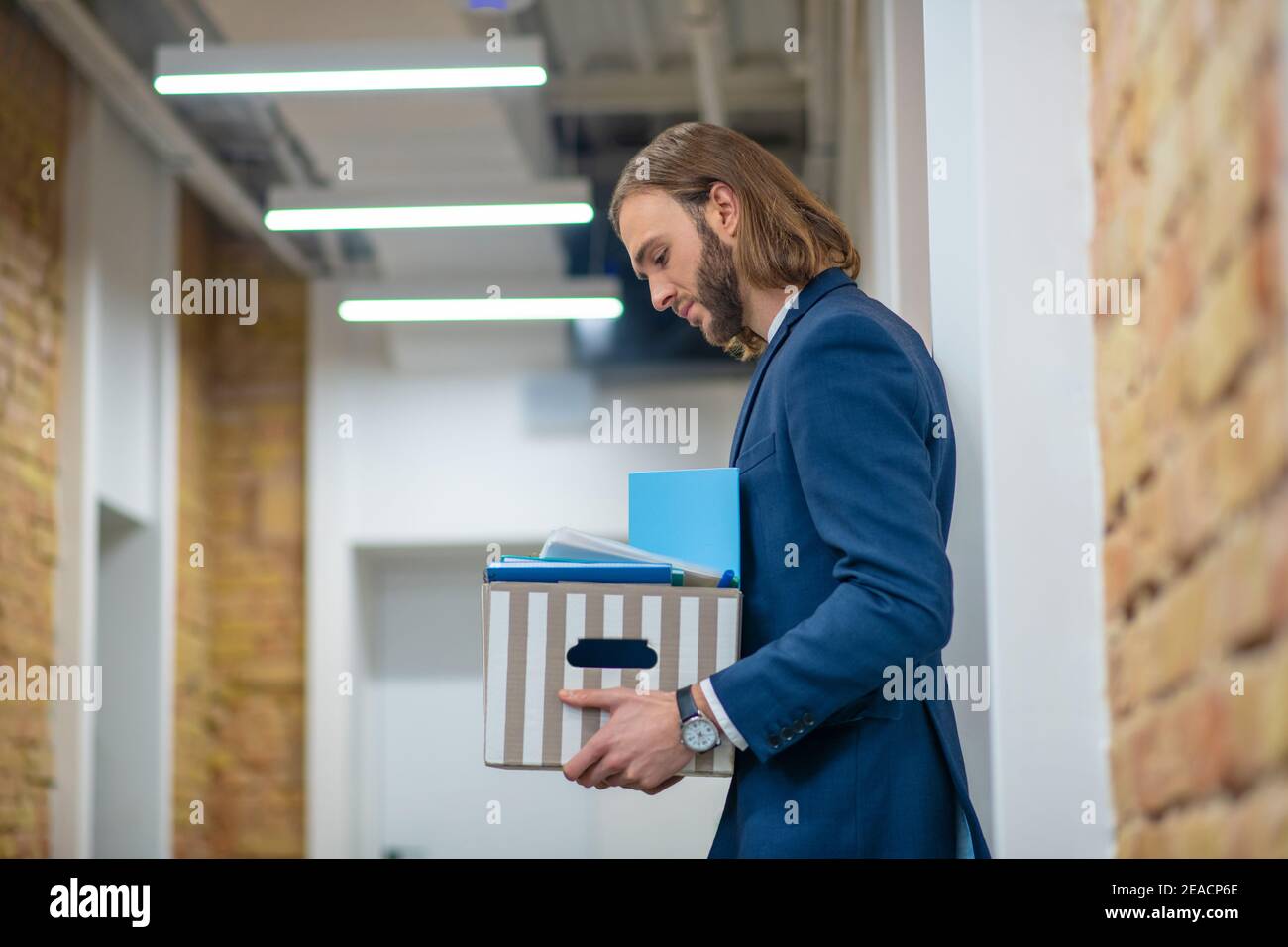 Man looking at box with personal belongings Stock Photo - Alamy