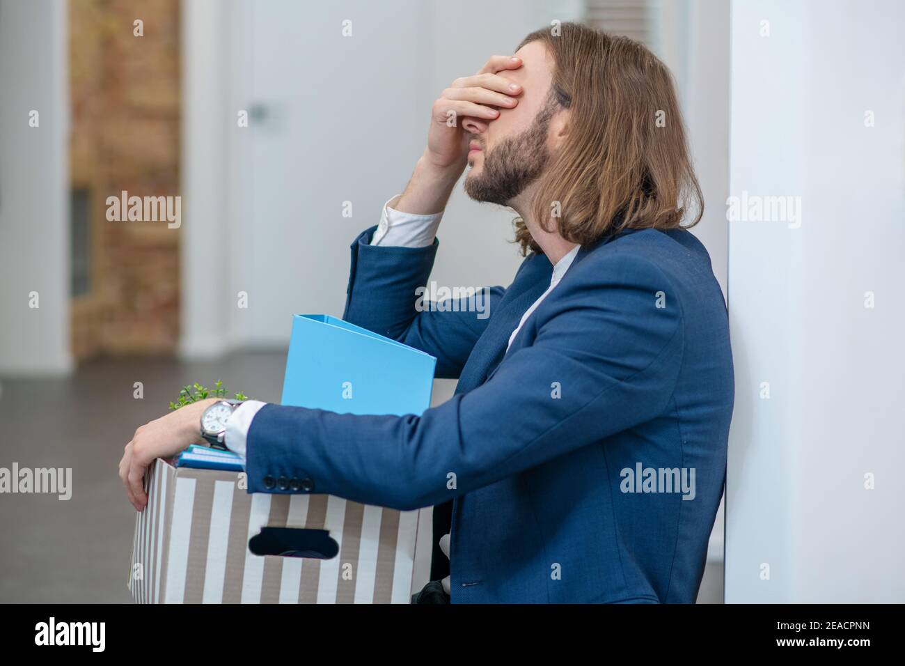 Man fired from work in office corridor Stock Photo - Alamy
