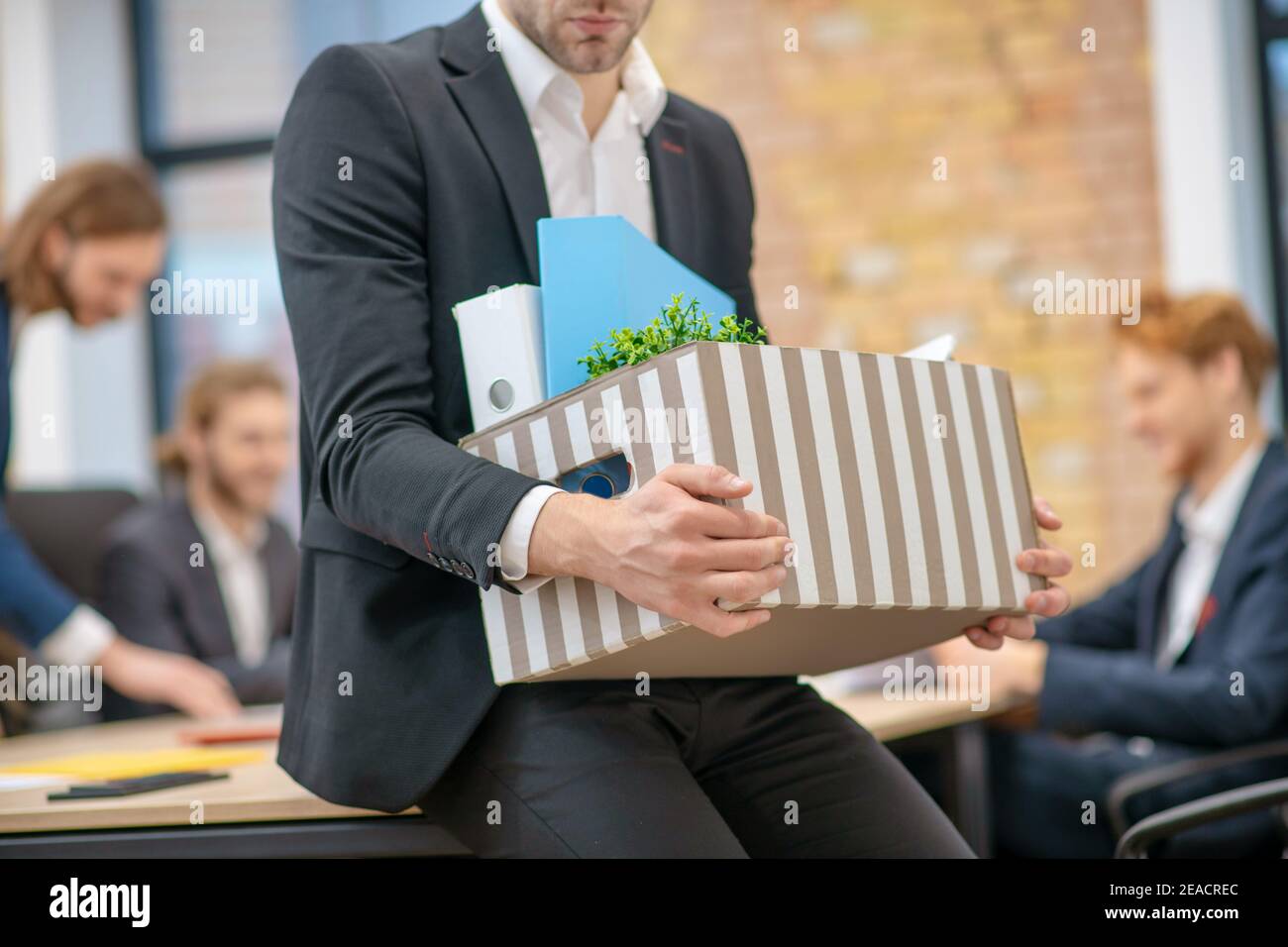 Man with striped box in hands, without face Stock Photo - Alamy