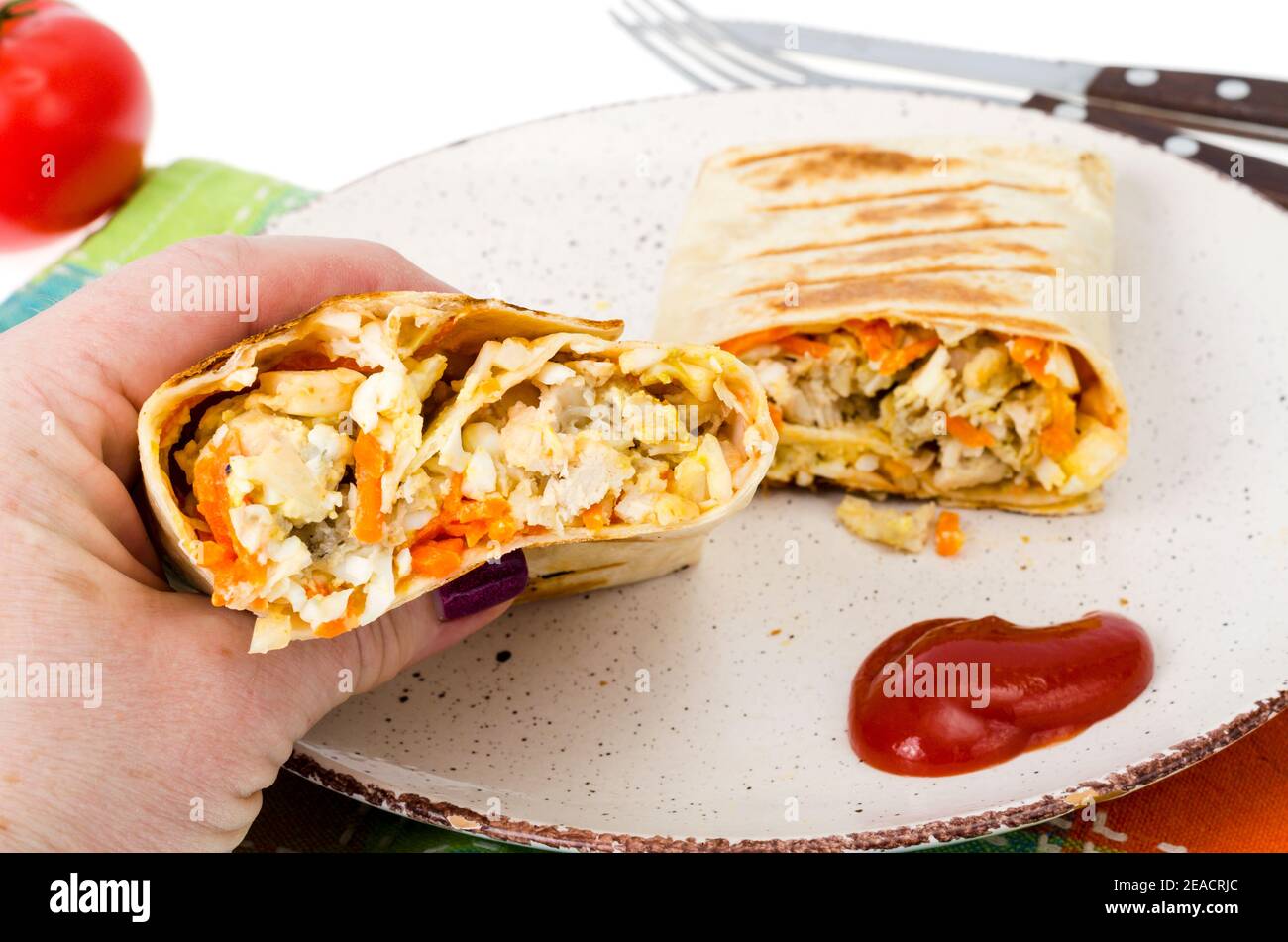 Hand holds piece of shawarma with meat. Studio Photo Stock Photo - Alamy