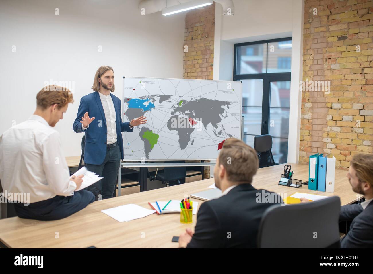 Group of young man in office at presentation Stock Photo - Alamy