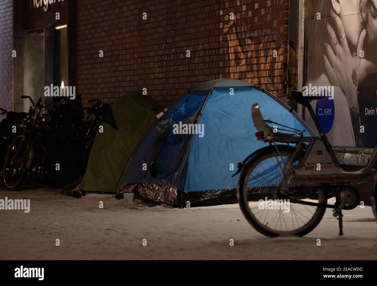 Berlin, Germany. 09th Feb, 2021. Homeless people sleep in tents under a ...