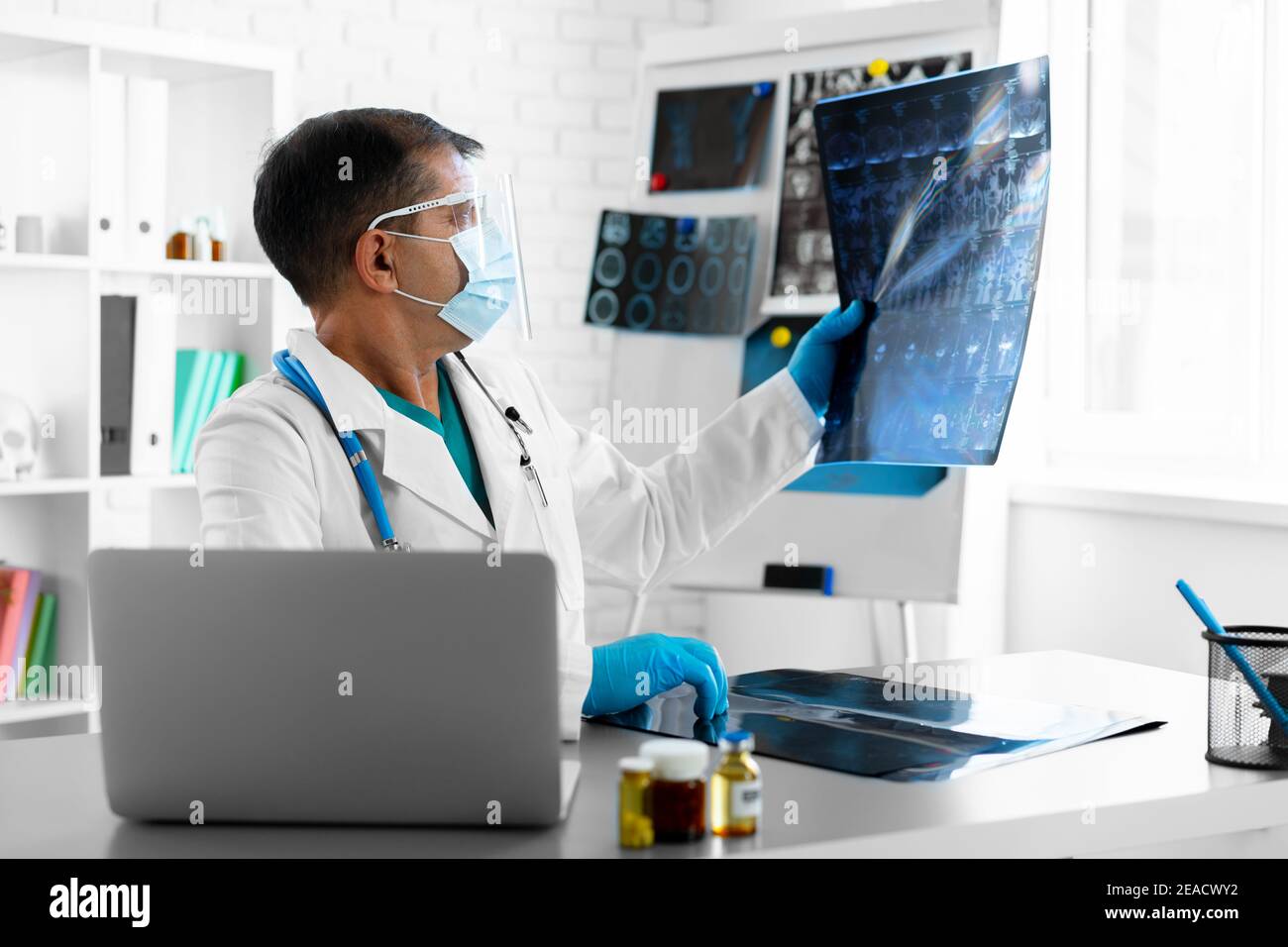 Doctor examining lungs x-ray scan in his office in hospital Stock Photo ...