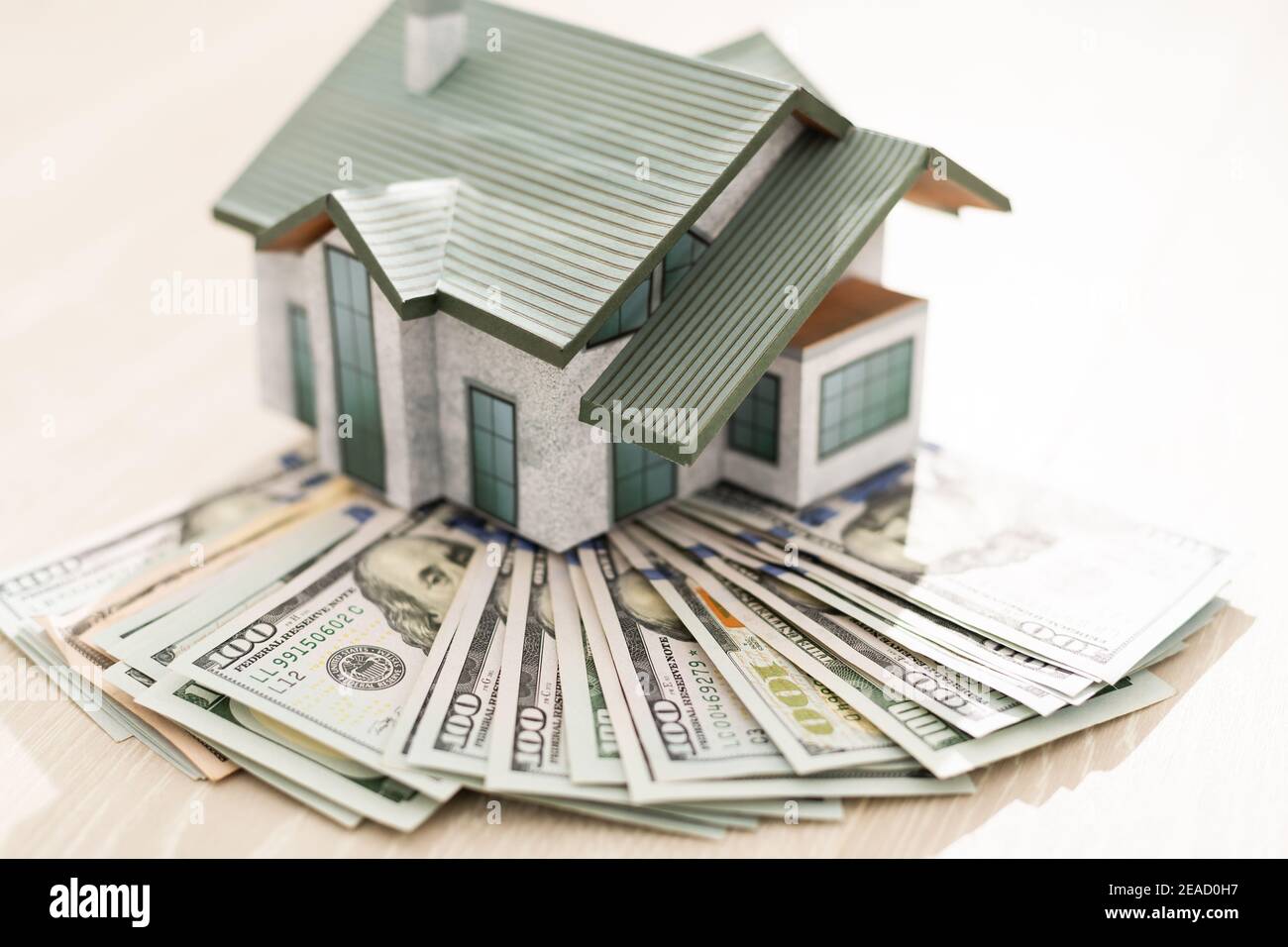 the layout of the house is on a pile of money Stock Photo - Alamy