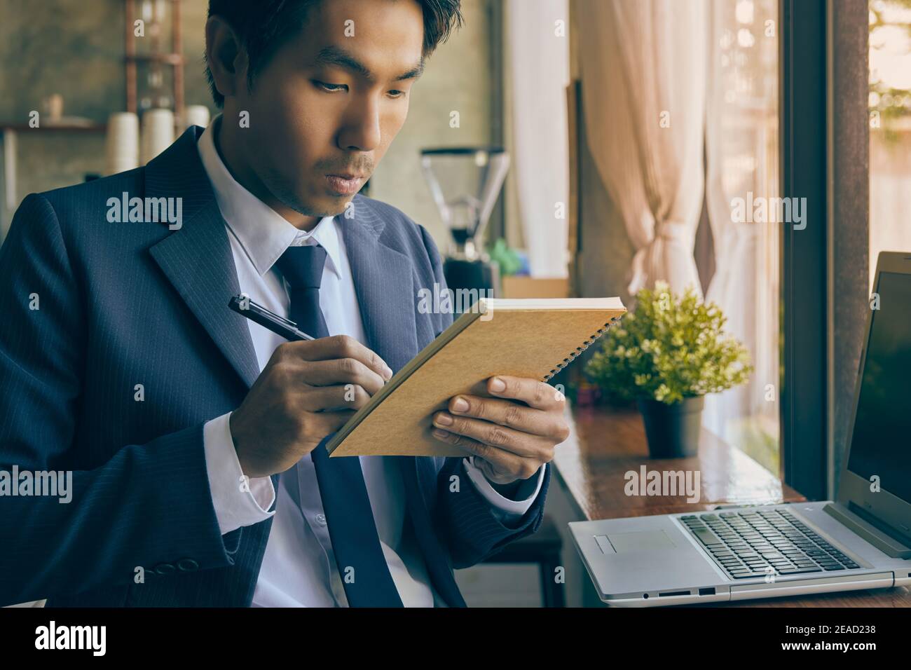 Front Right Asian Businessman in Suit Write Summary Report in Notebook ...
