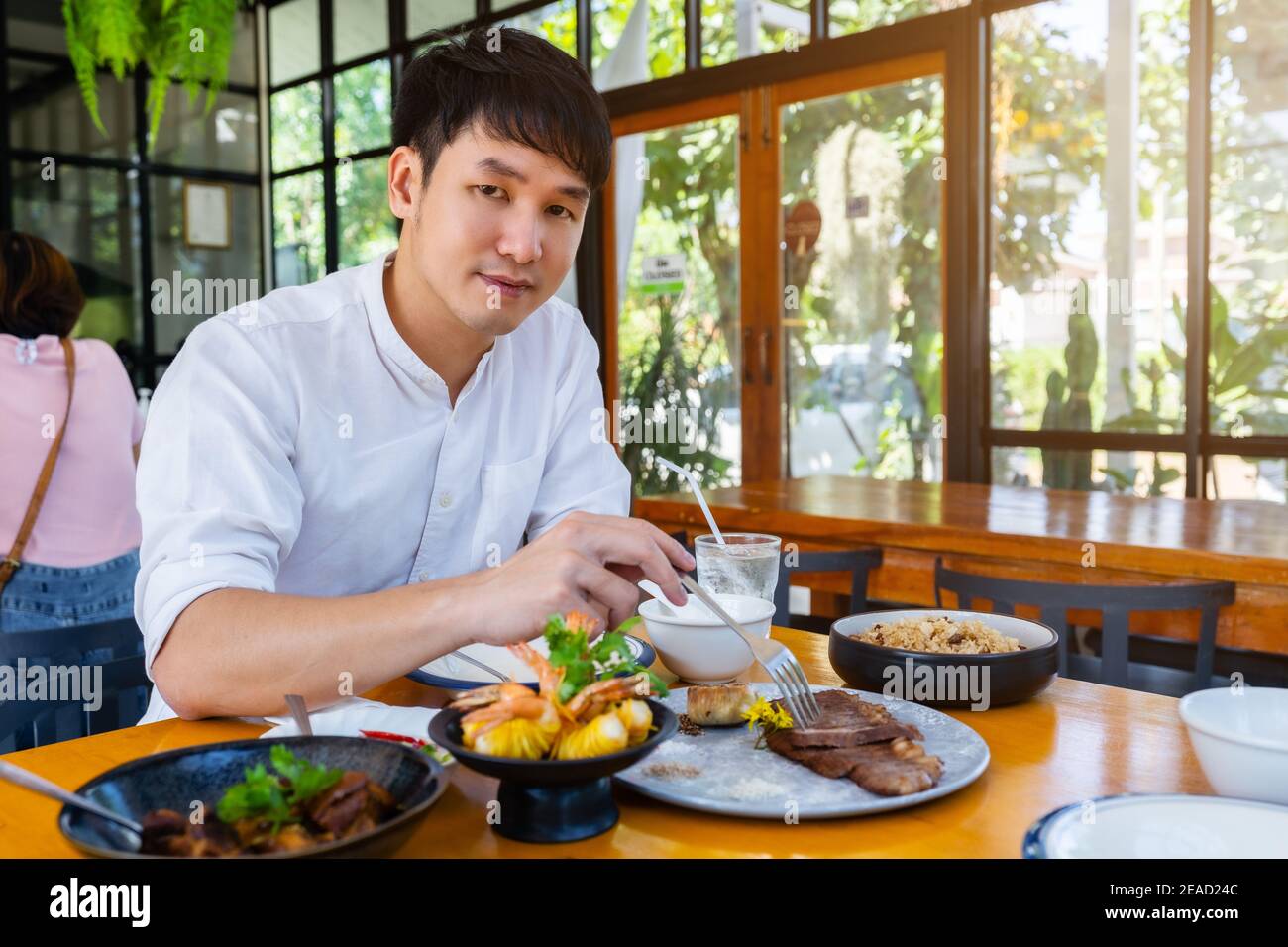 man eating food in the restaurant Stock Photo - Alamy