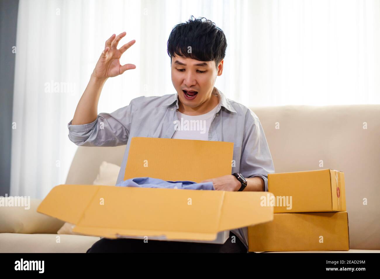 surprise man open cardboard parcel box in the living room at home ...