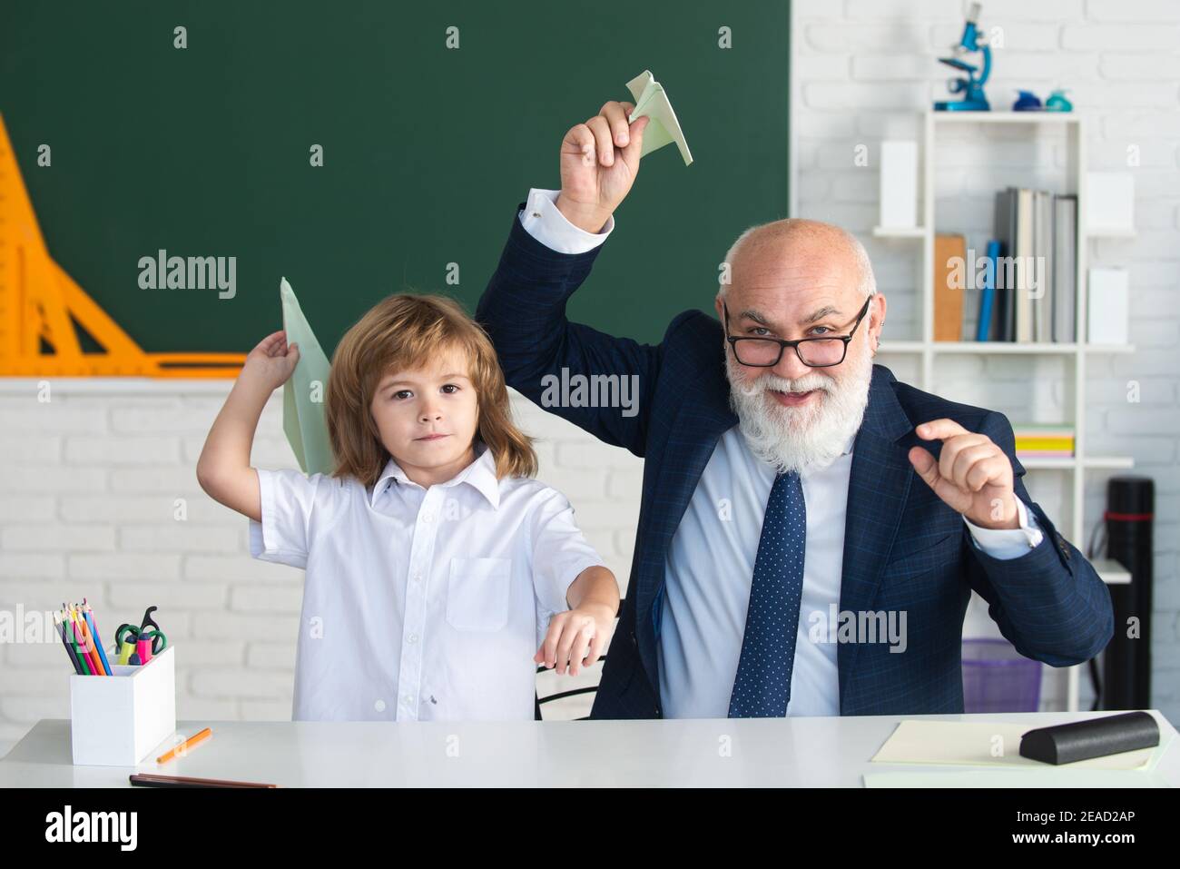 School break. Teacher with pupil with airplanes. Education, teachering ...