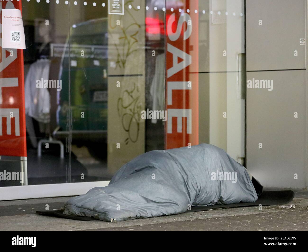 Cologne, Germany. 09th Feb, 2021. A homeless person sleeps in front of ...