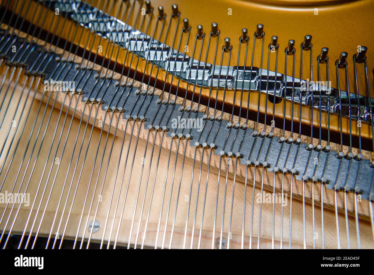A close-up of the internal string structure of a top grand piano Stock ...