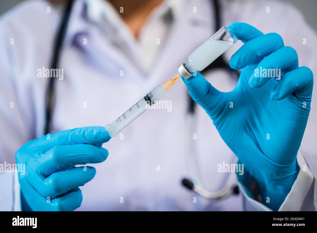 doctor drawing vaccine bottle into syringe injection medicine Stock ...