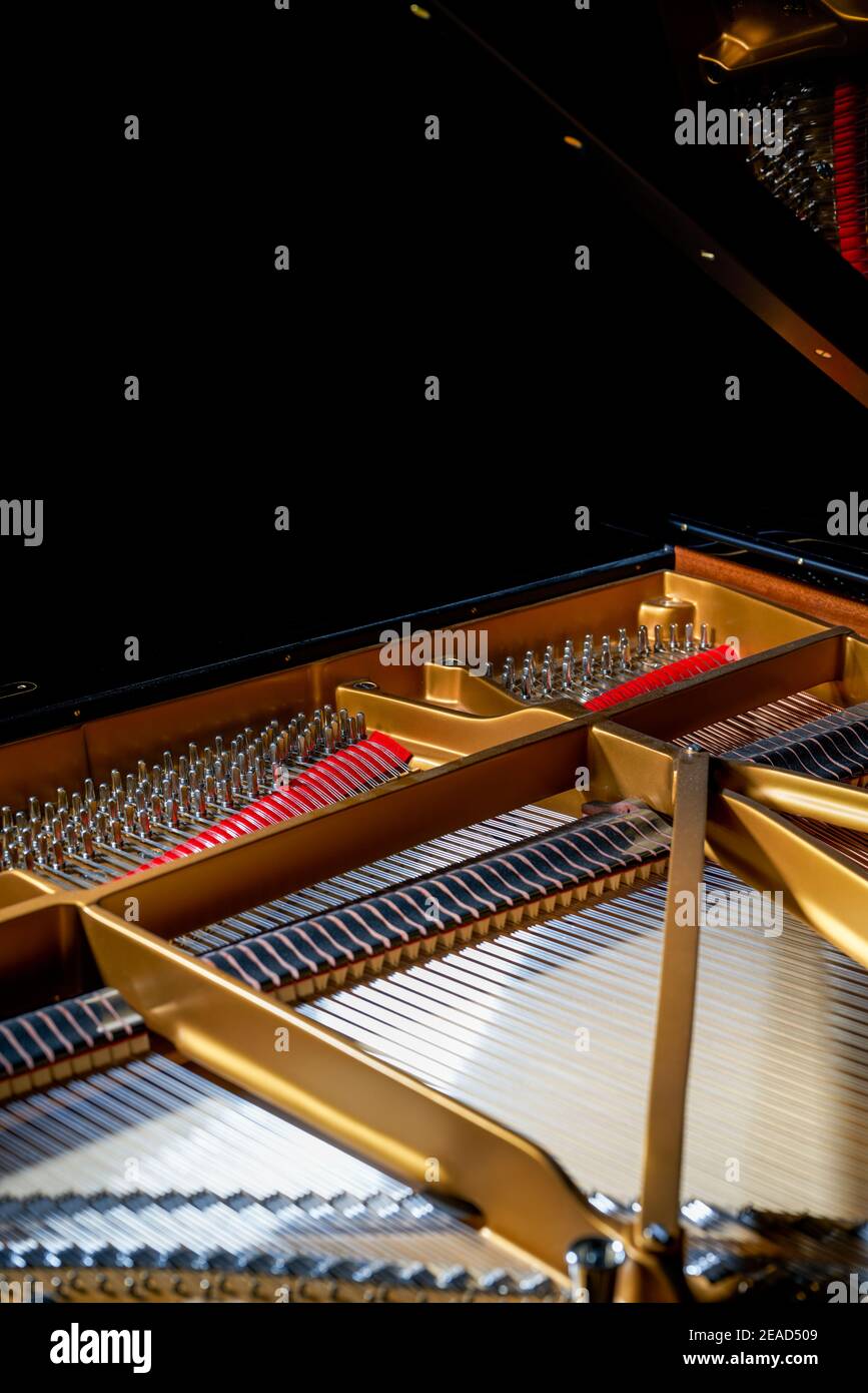 A close-up of the internal string structure of a top grand piano Stock ...