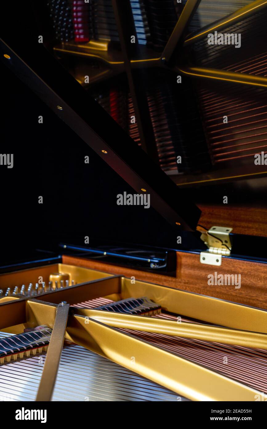 A close-up of the internal string structure of a top grand piano Stock ...