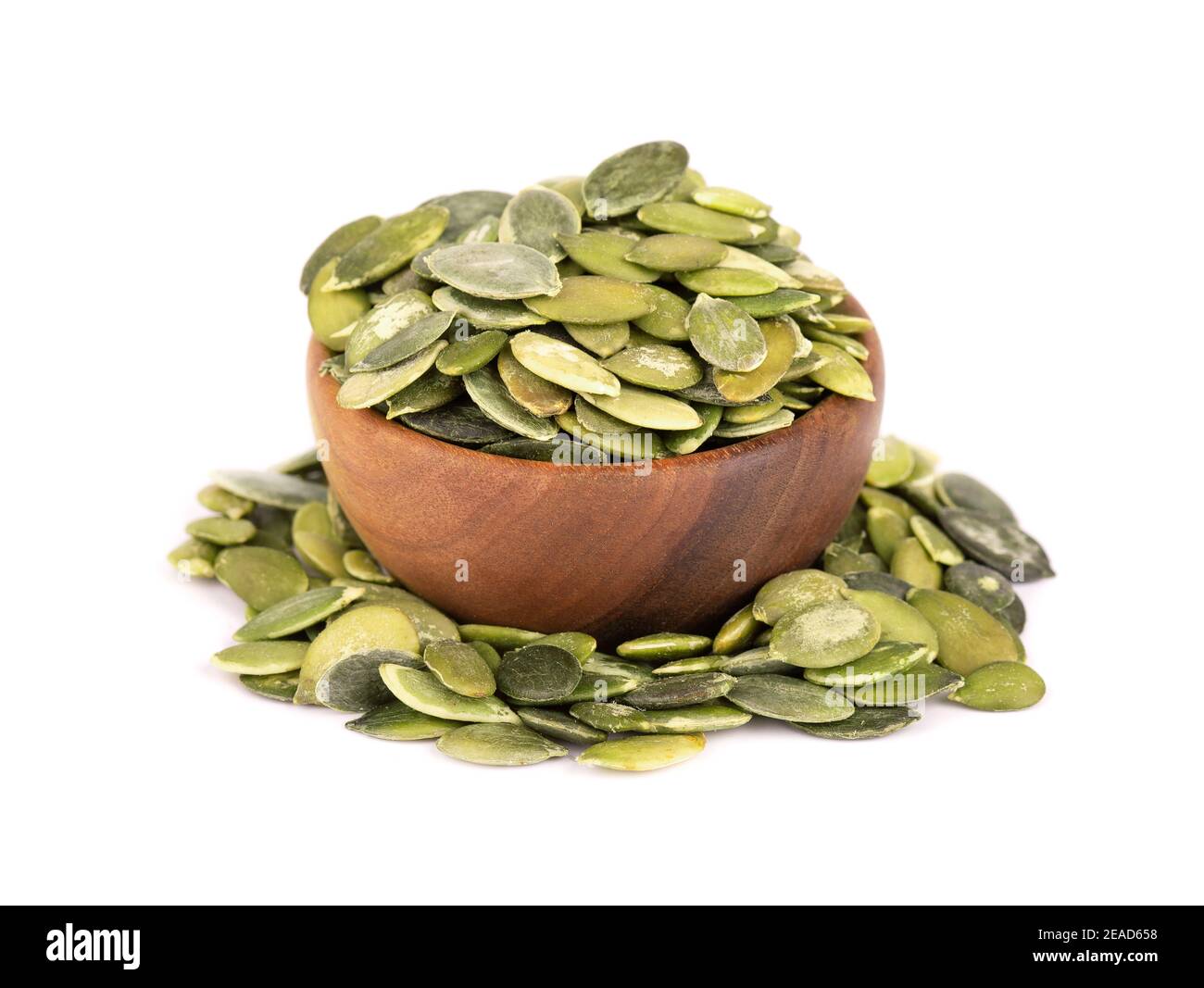 Pumpkin seeds in wooden bowl, isolated on white background. Green ...