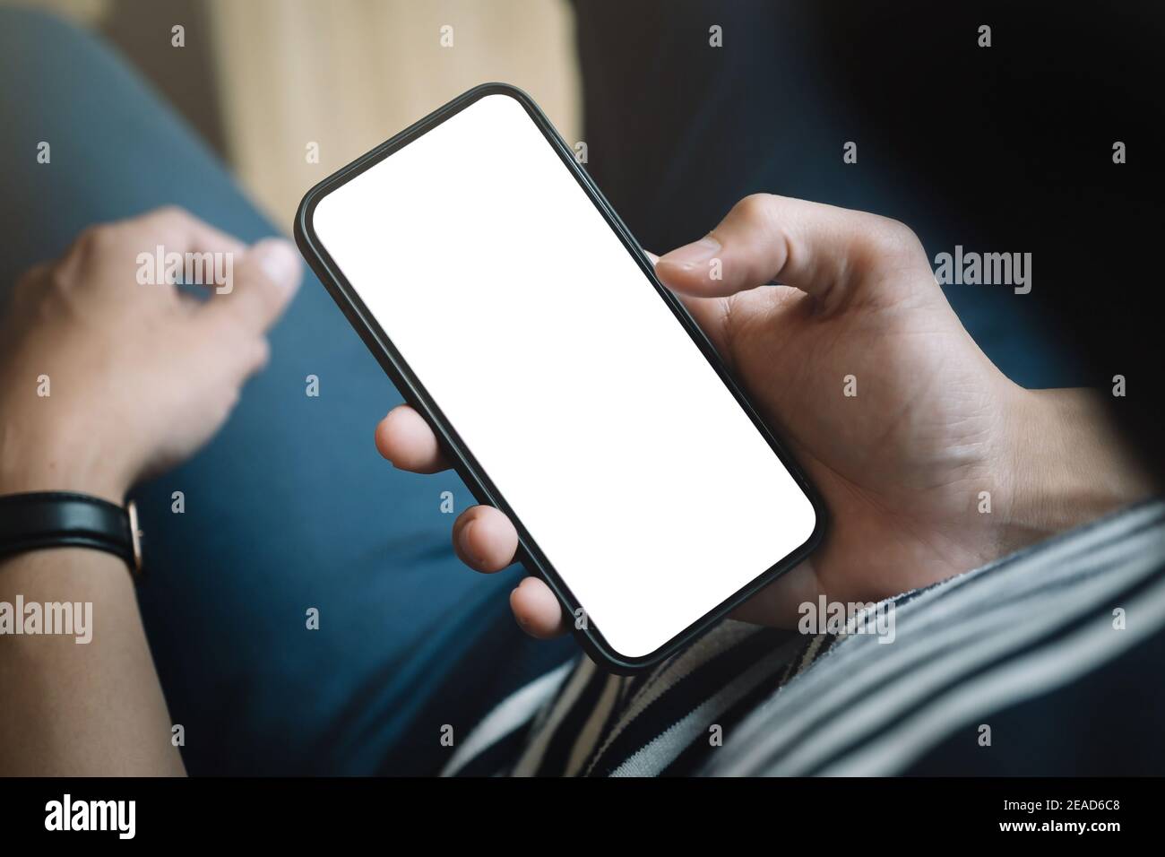 Top view man sitting and holding blank screen mock up mobile phone ...