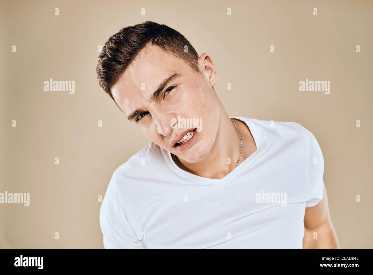 Man with displeased facial expression emotions white t-shirt gestures ...