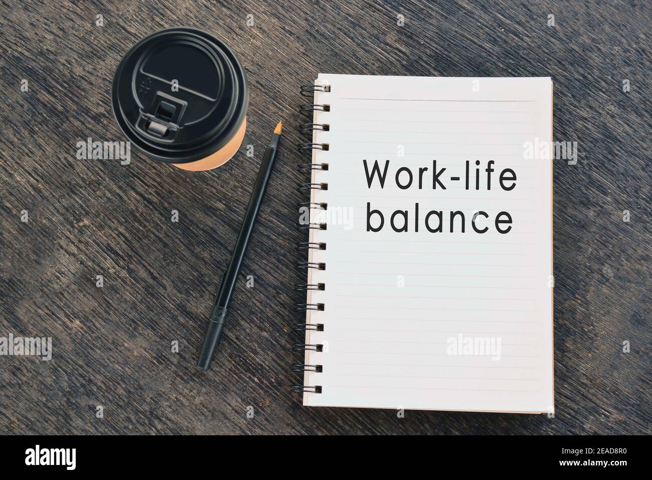 Work life balance text on notepad with disposable coffee cup and pen on ...