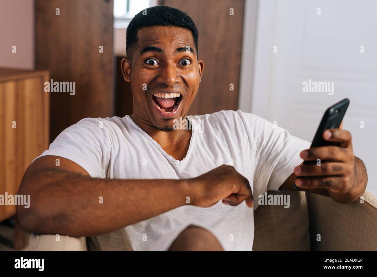 Close-up face of surprised African-American man receiving good news ...